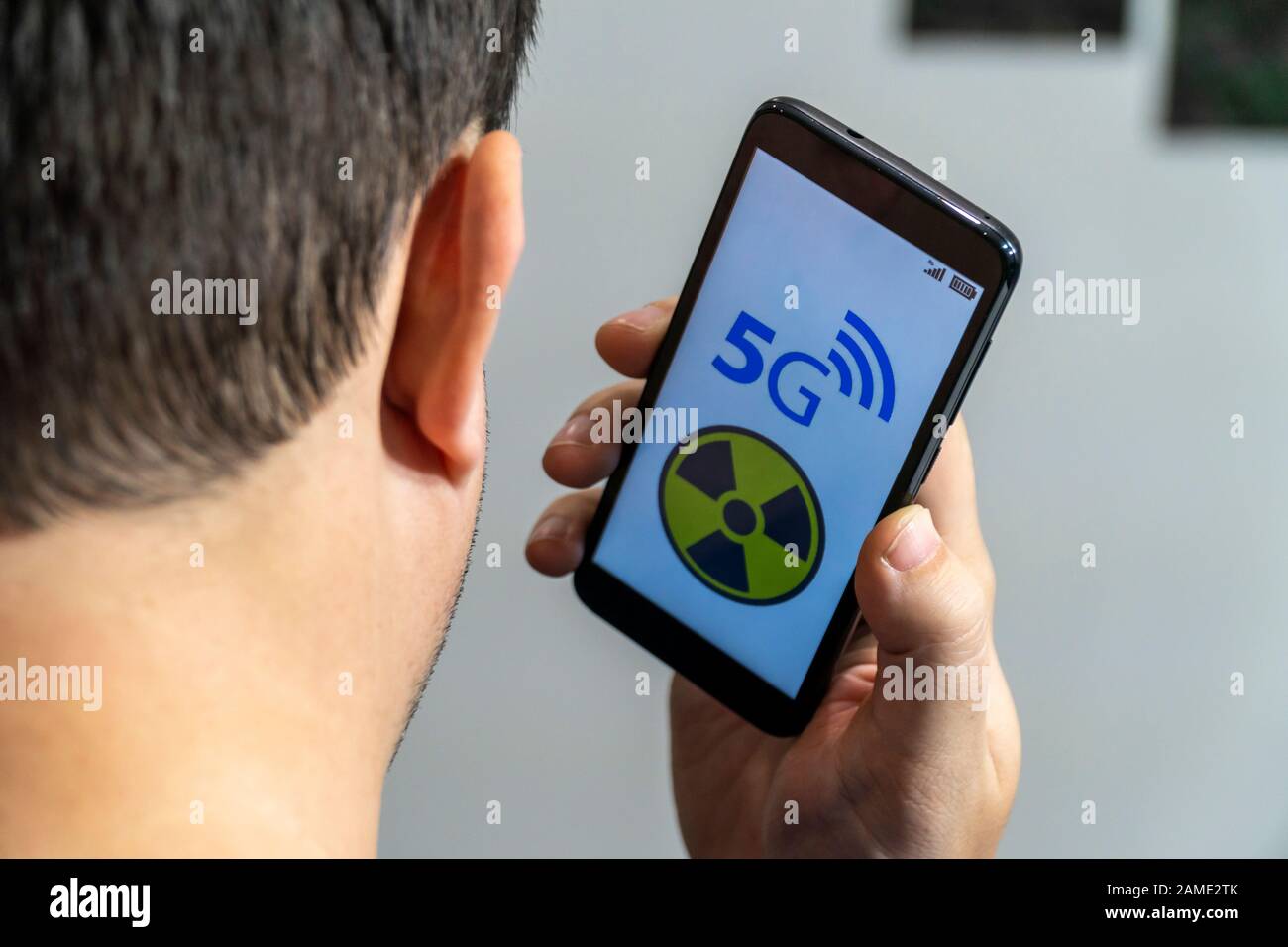 5g network danger concept. Man putting a smartphone to his ear. Back ...