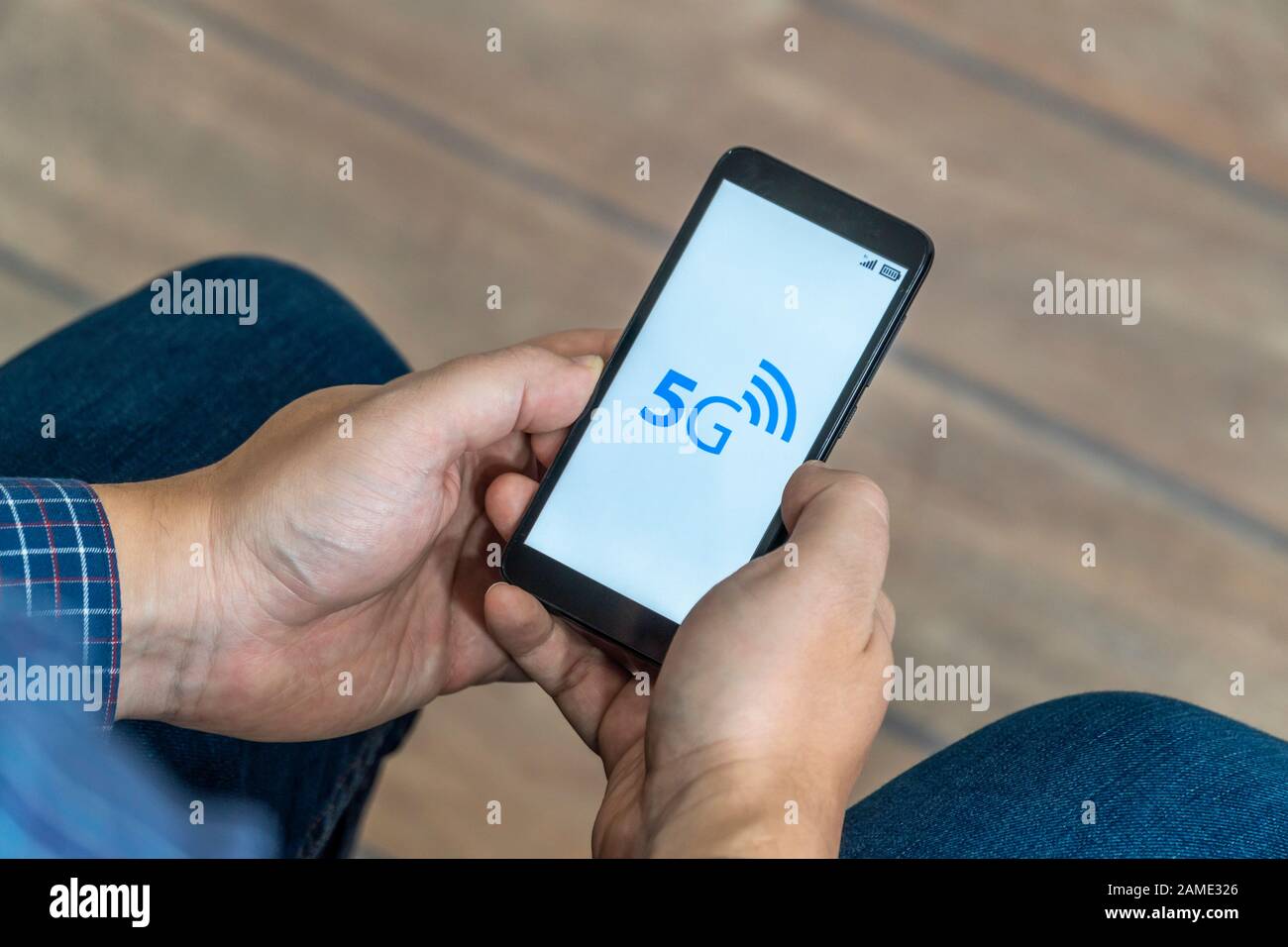 5g network speed concept. Man checking his smartphone on 5g network and ...