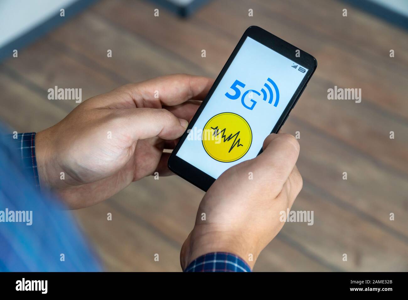 5g network danger concept. Man checking his smartphone with 5g network ...