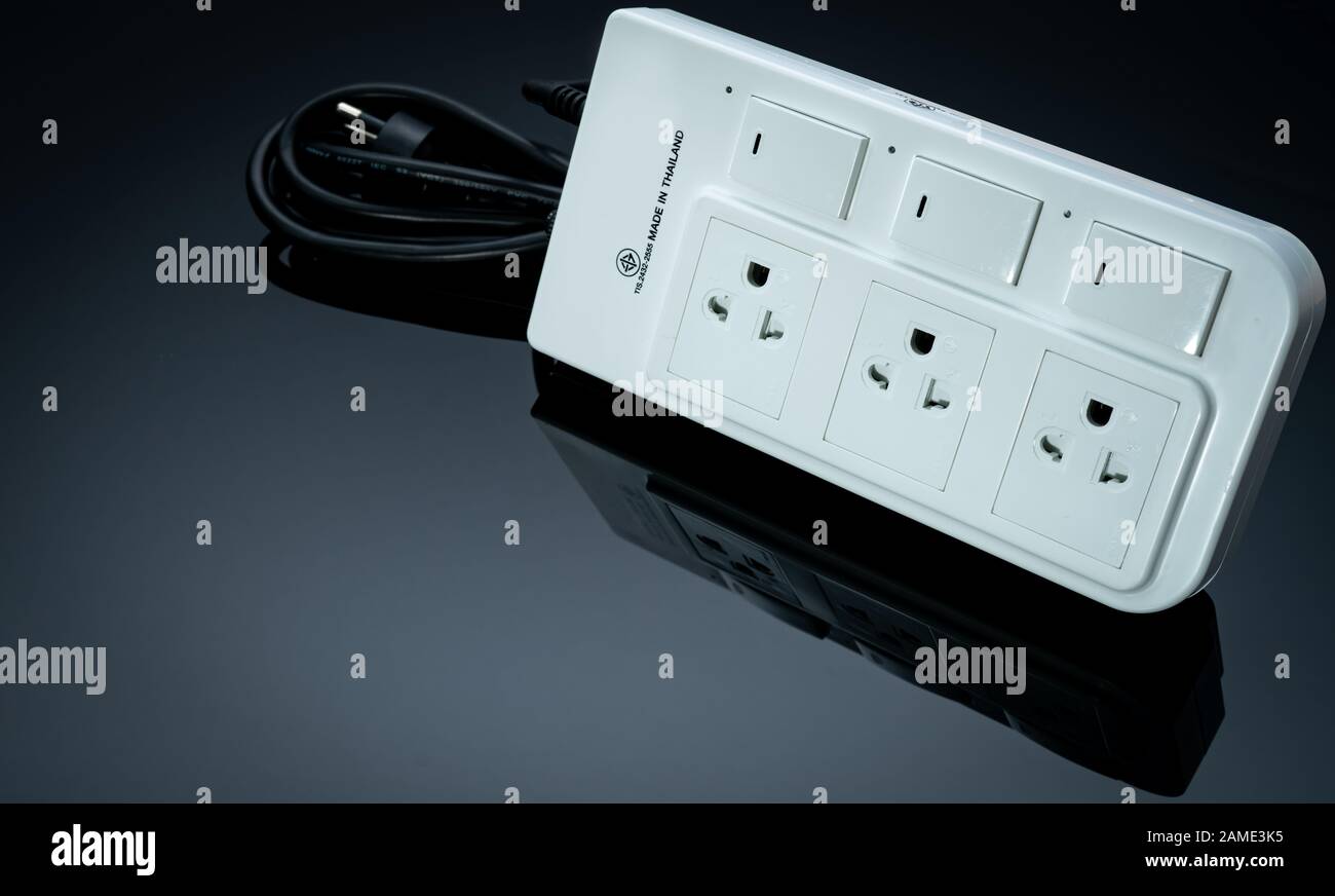 Power strip with three electrical standard socket on black background ...