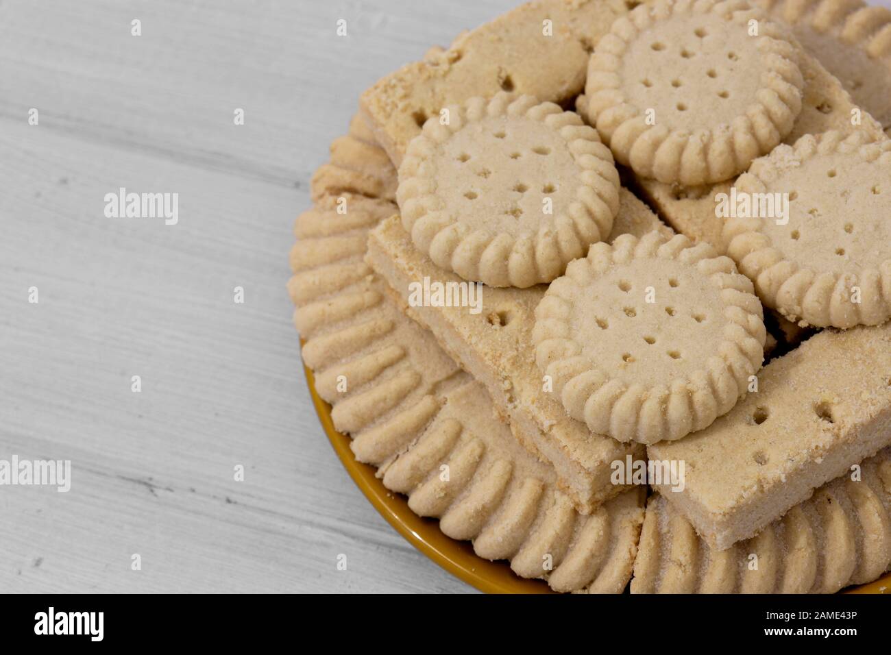 Shortbread biscuits cookies on brown plate. Grey wood background Stock ...