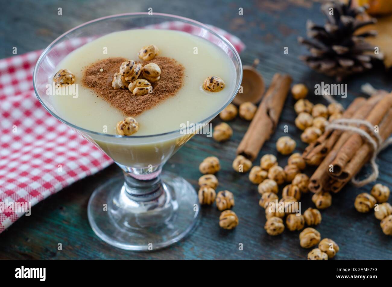 Traditional turkish drink; boza with cinnamon sticks and chickpea on ...