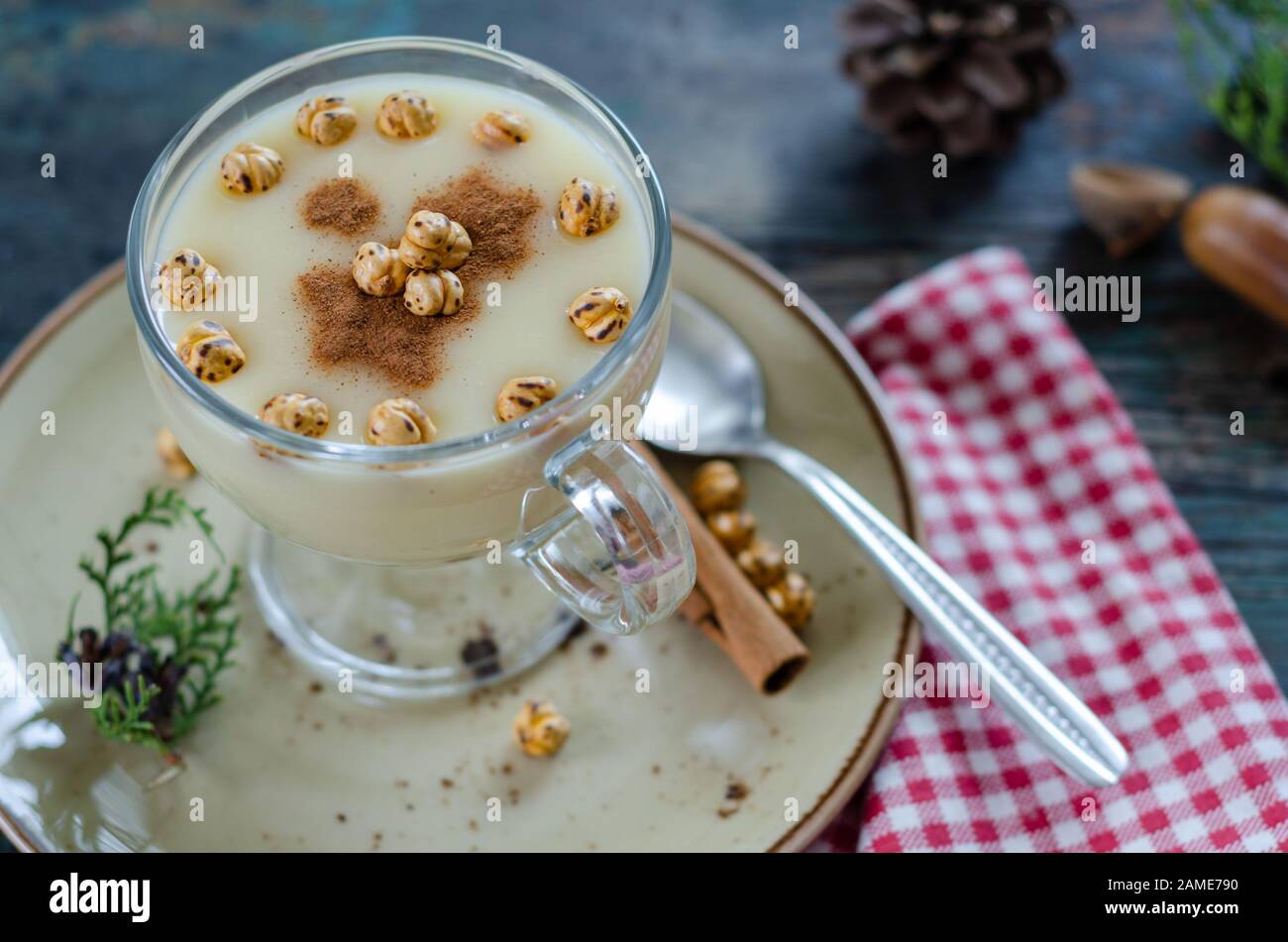 Traditional turkish drink; boza with cinnamon sticks and chickpea on ...