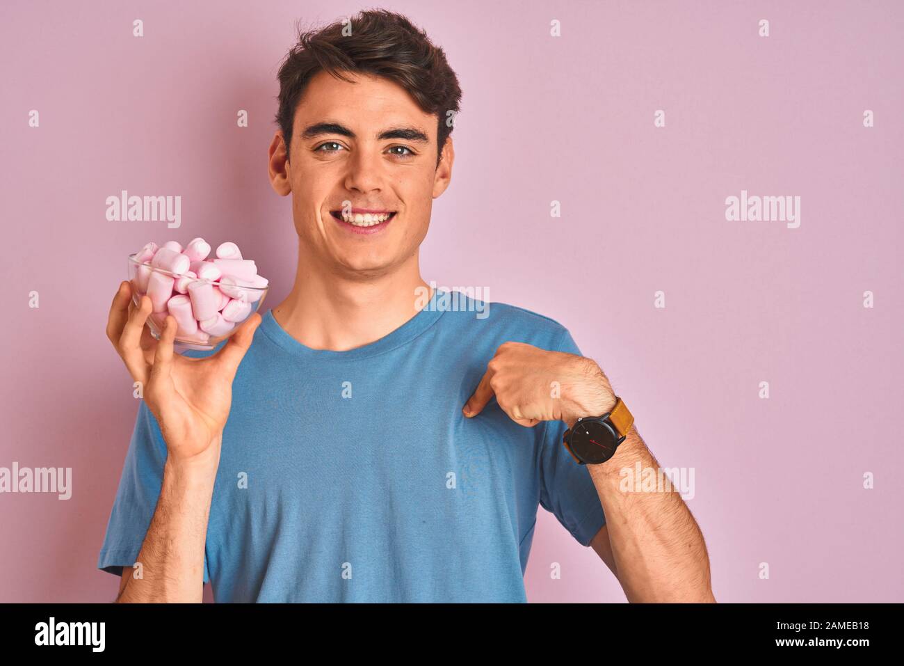 Teenager boy holding a bunch of delicious fluffy marshmallow over ...