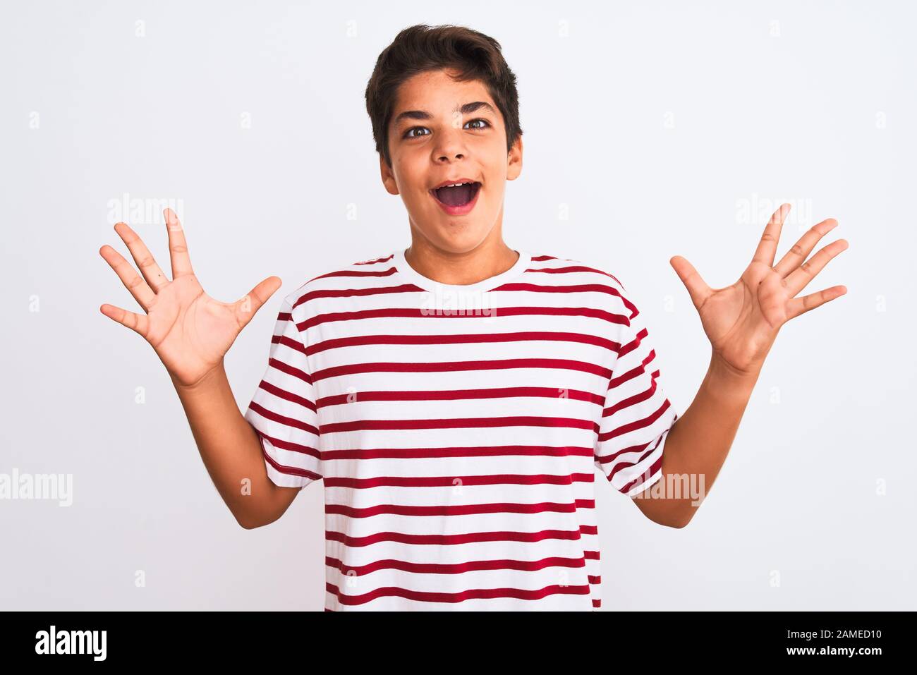 Handsome teenager boy standing over white isolated background ...
