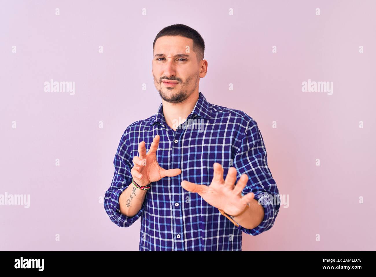 Young handsome man standing over isolated background disgusted ...