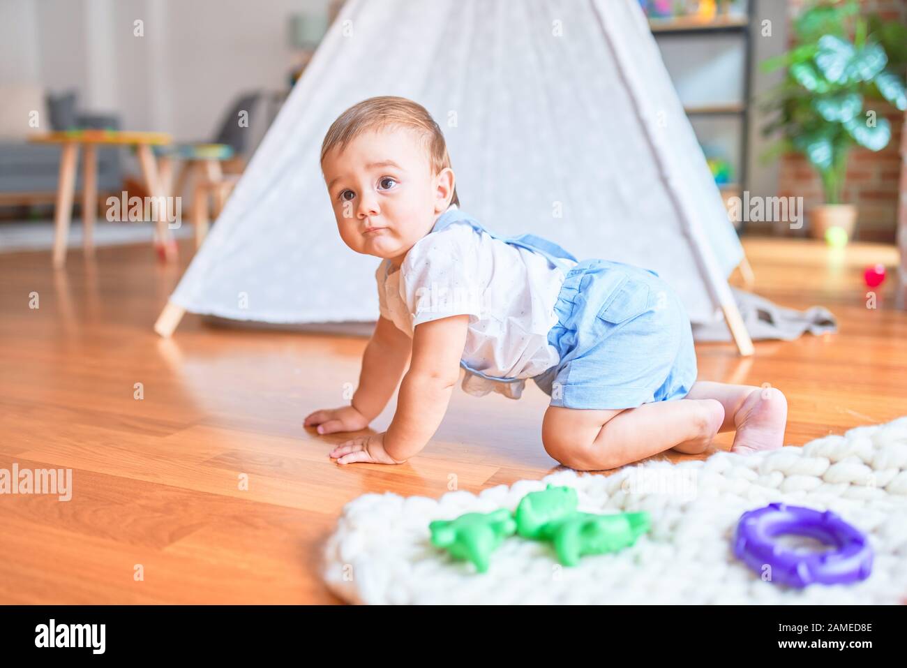 Beautiful toddler crawling at kindergarten Stock Photo - Alamy