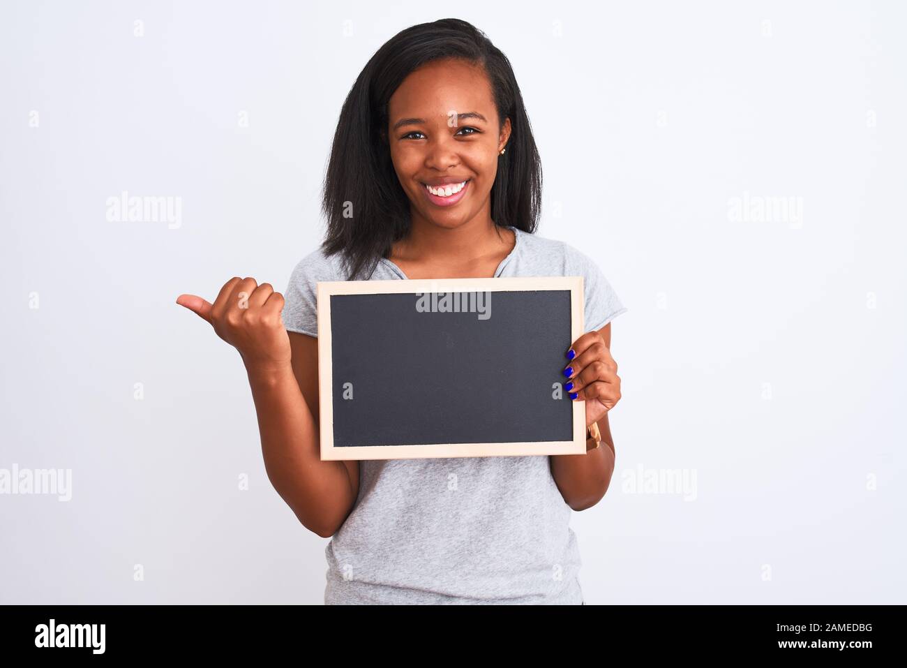 Young african american woman holding blank school blackboard over ...