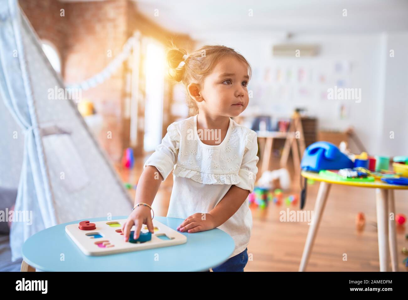Young beautiful toddler learning mathematics playing with maths game at ...