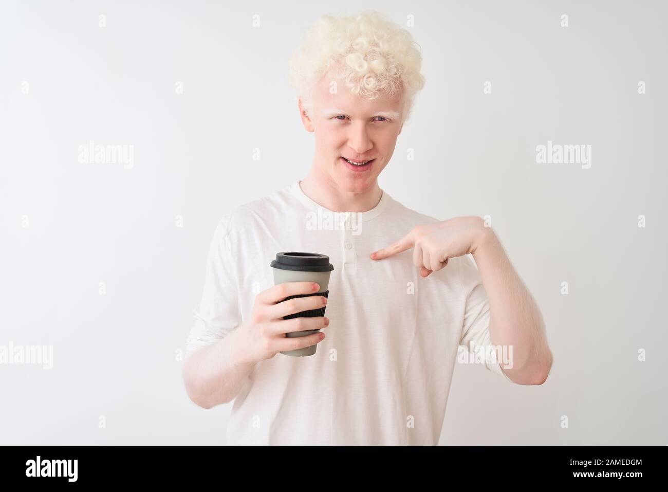 Young albino blond man drinking coffee standing over isolated white ...