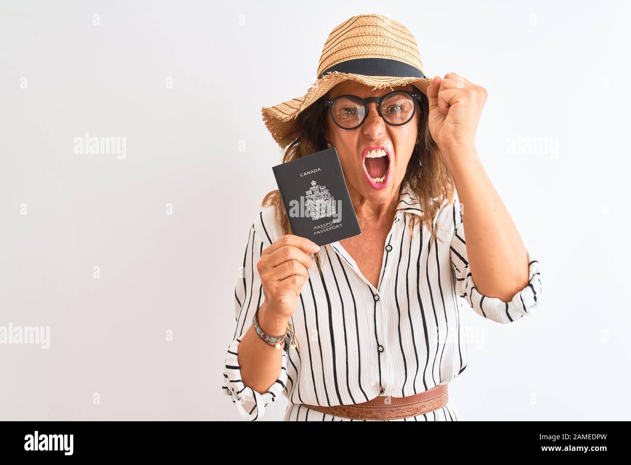 Senior tourist woman holding Canadian Canada passport over isolated ...