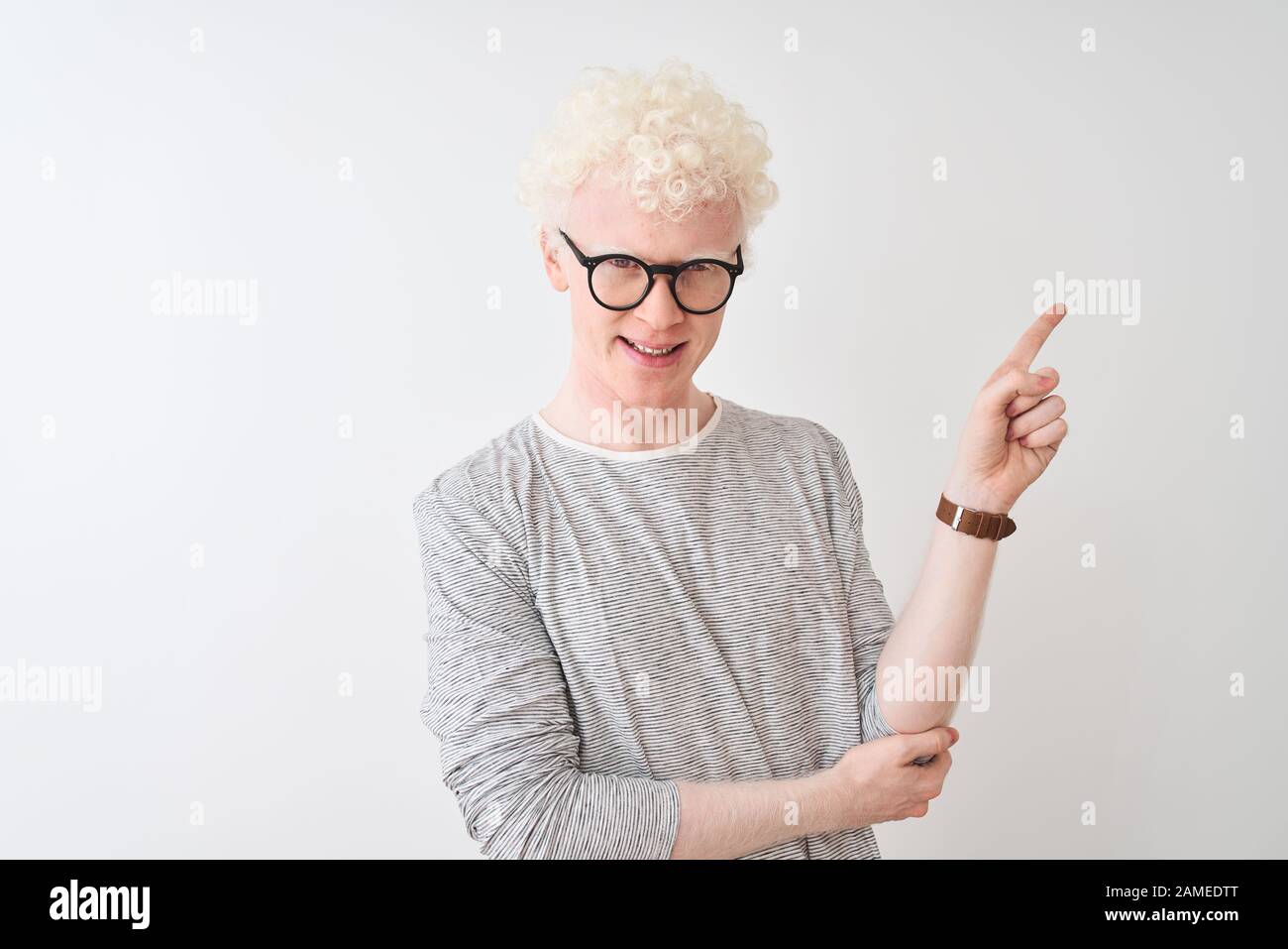 Young albino blond man wearing striped t-shirt and glasses over ...