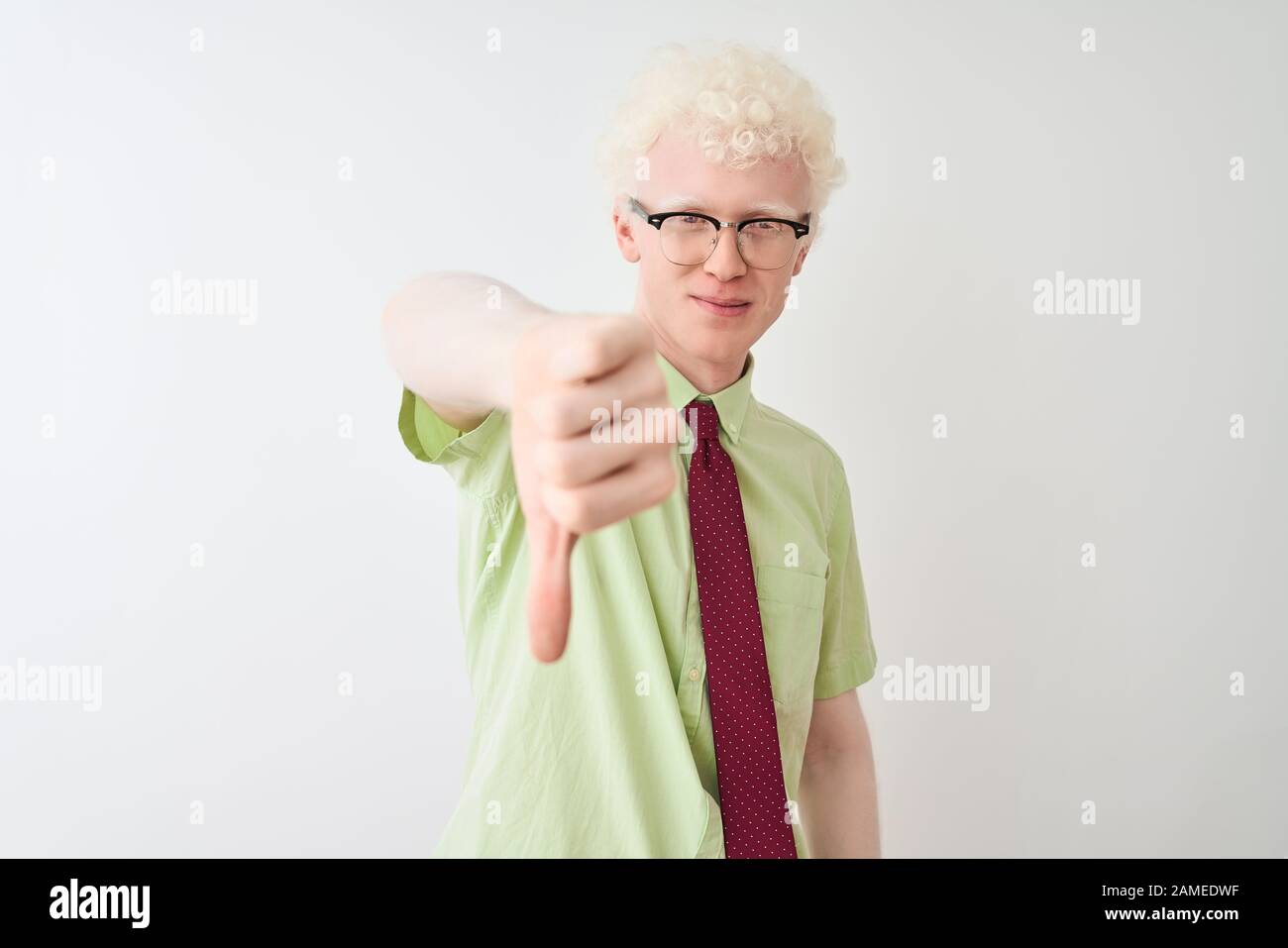 Young albino businessman wearing shirt and tie standing over isolated ...
