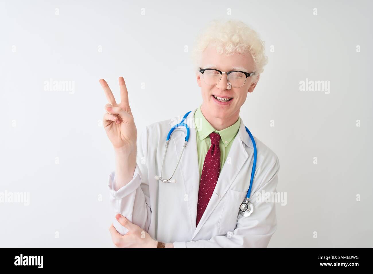 Young albino doctor man wearing stethoscope standing over isolated ...