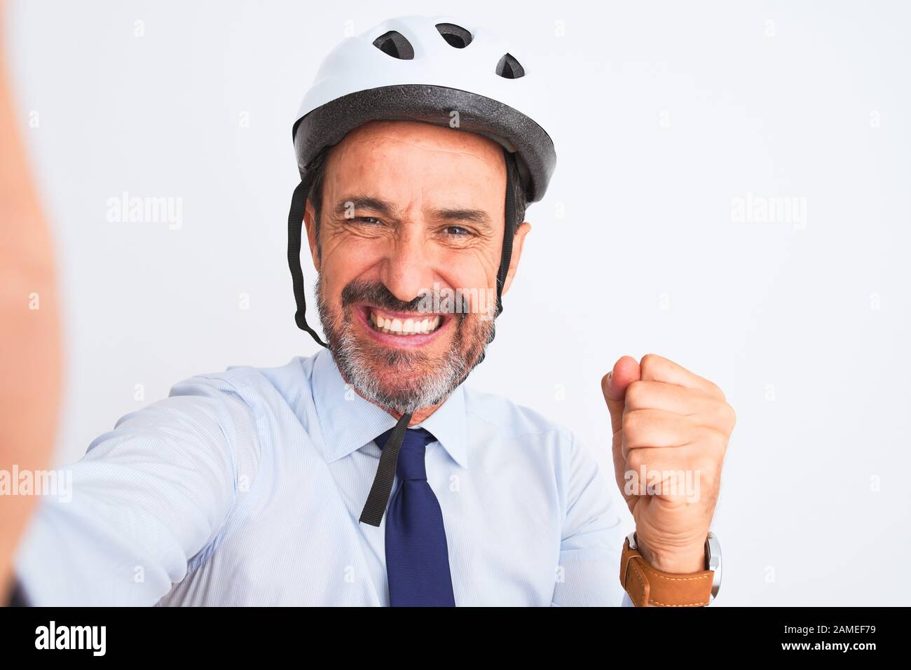 Middle age businessman wearing bike helmet make selfie over isolated ...