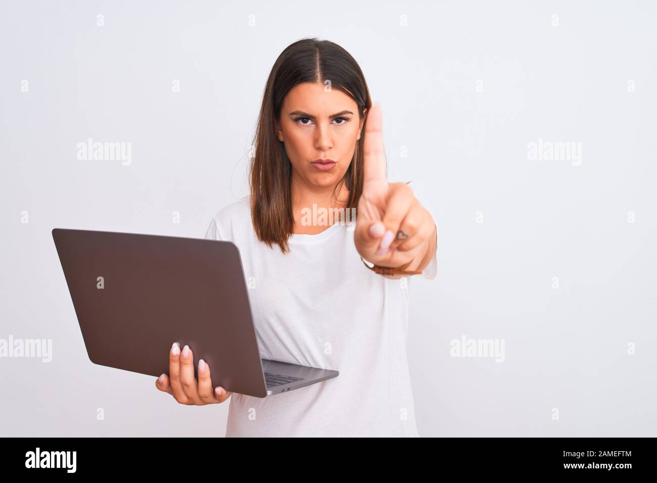 Beautiful young woman working using computer laptop over white ...