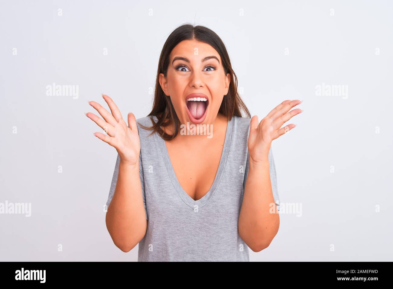 Portrait of beautiful young woman standing over isolated white ...