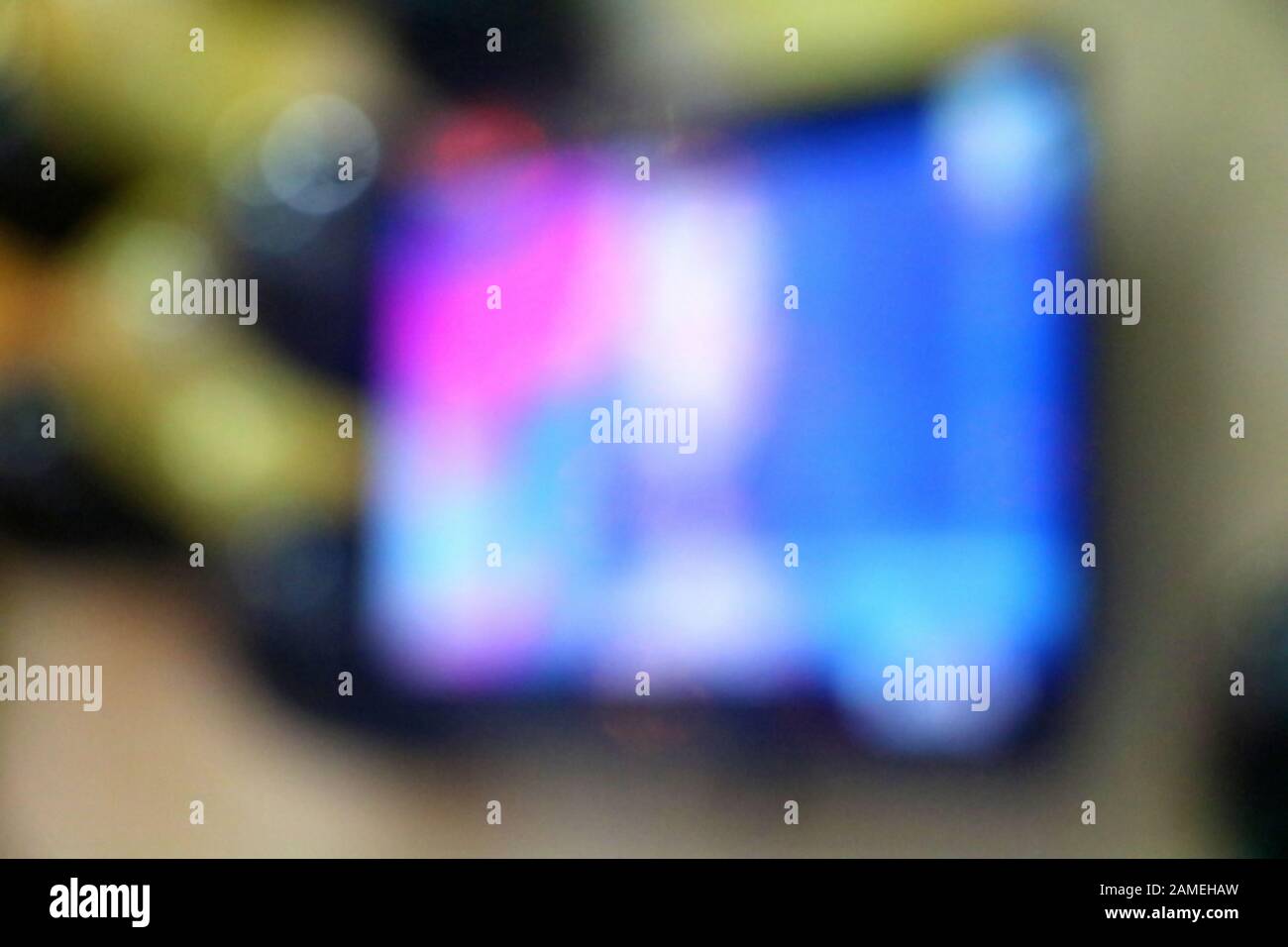 TV on the wall, Blurred background of TV at home Stock Photo - Alamy