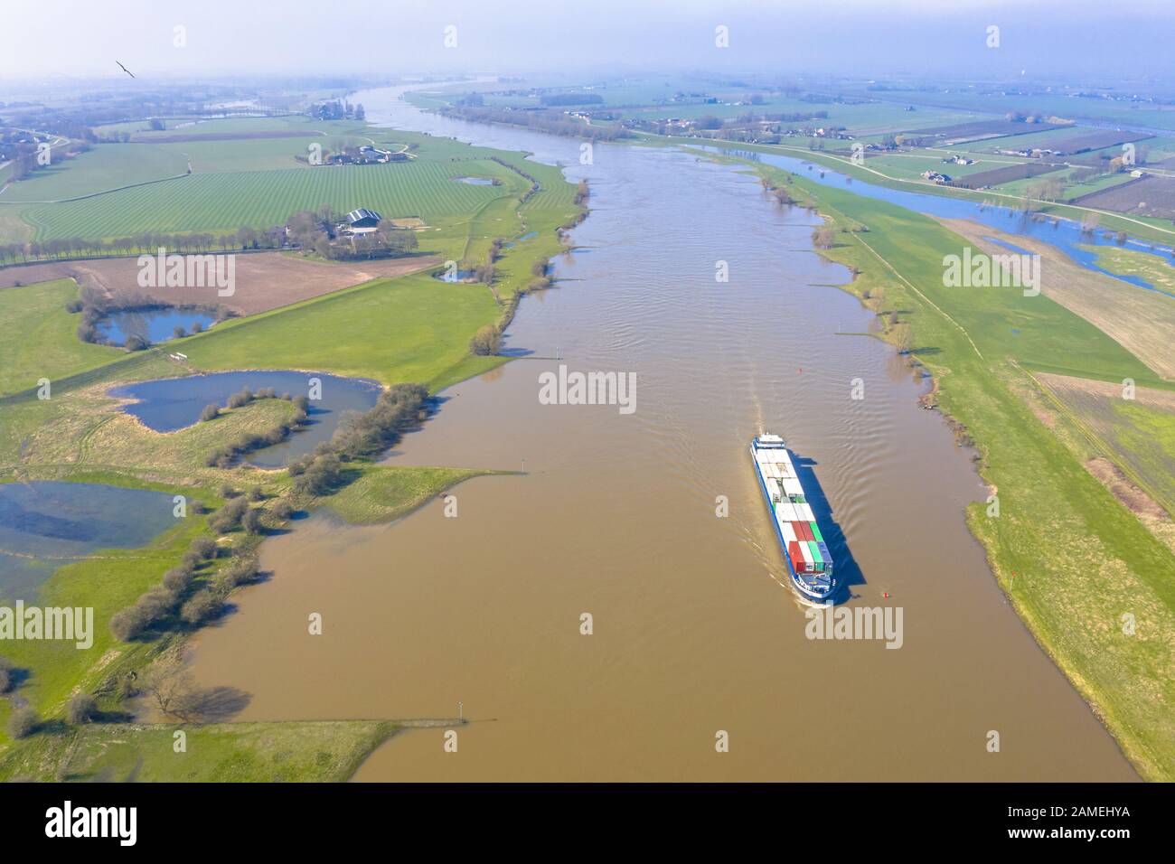 Inland container barge on River Lek aerial view near the village of ...
