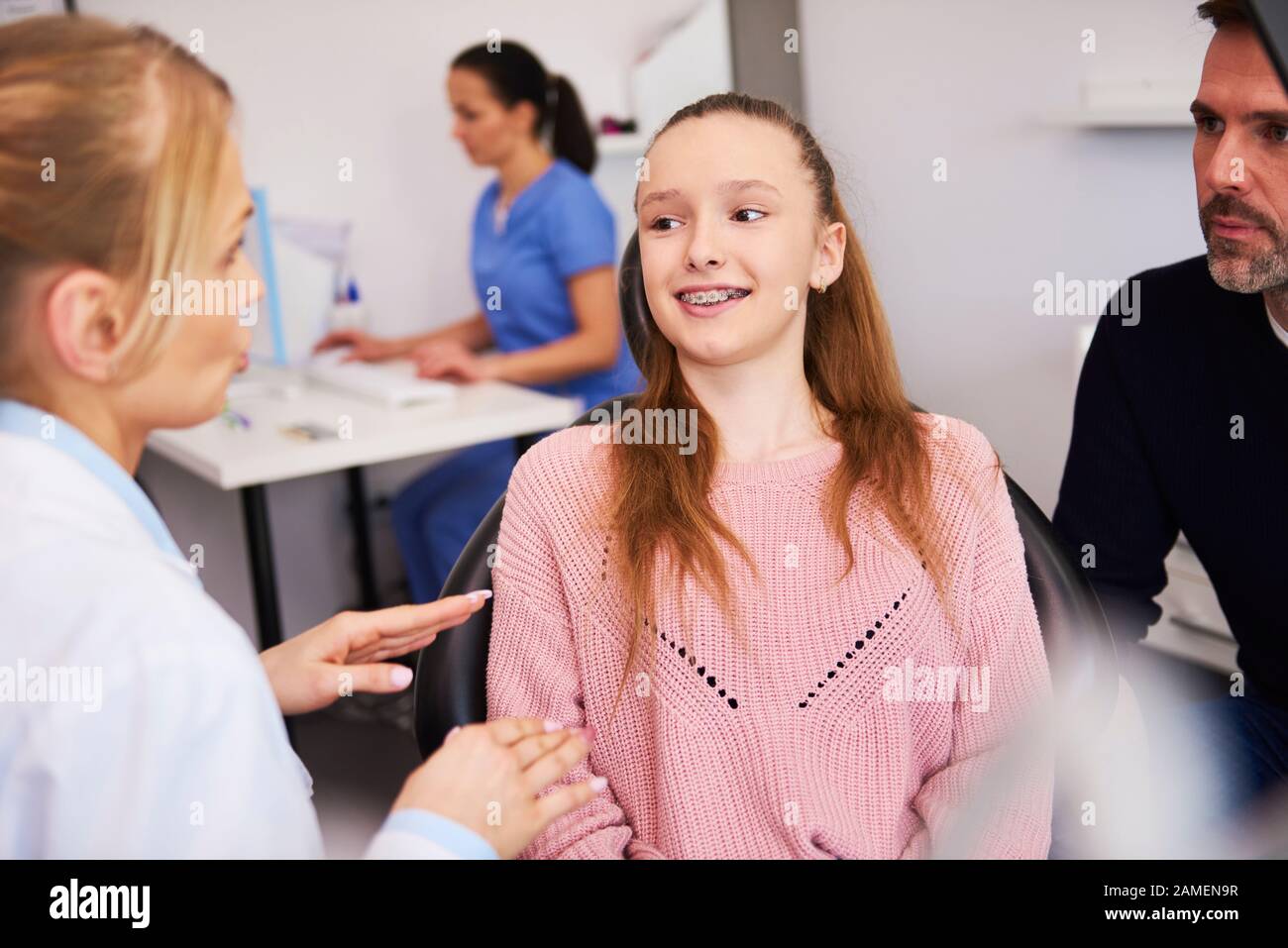 Female dentist and patient making a conversation Stock Photo - Alamy