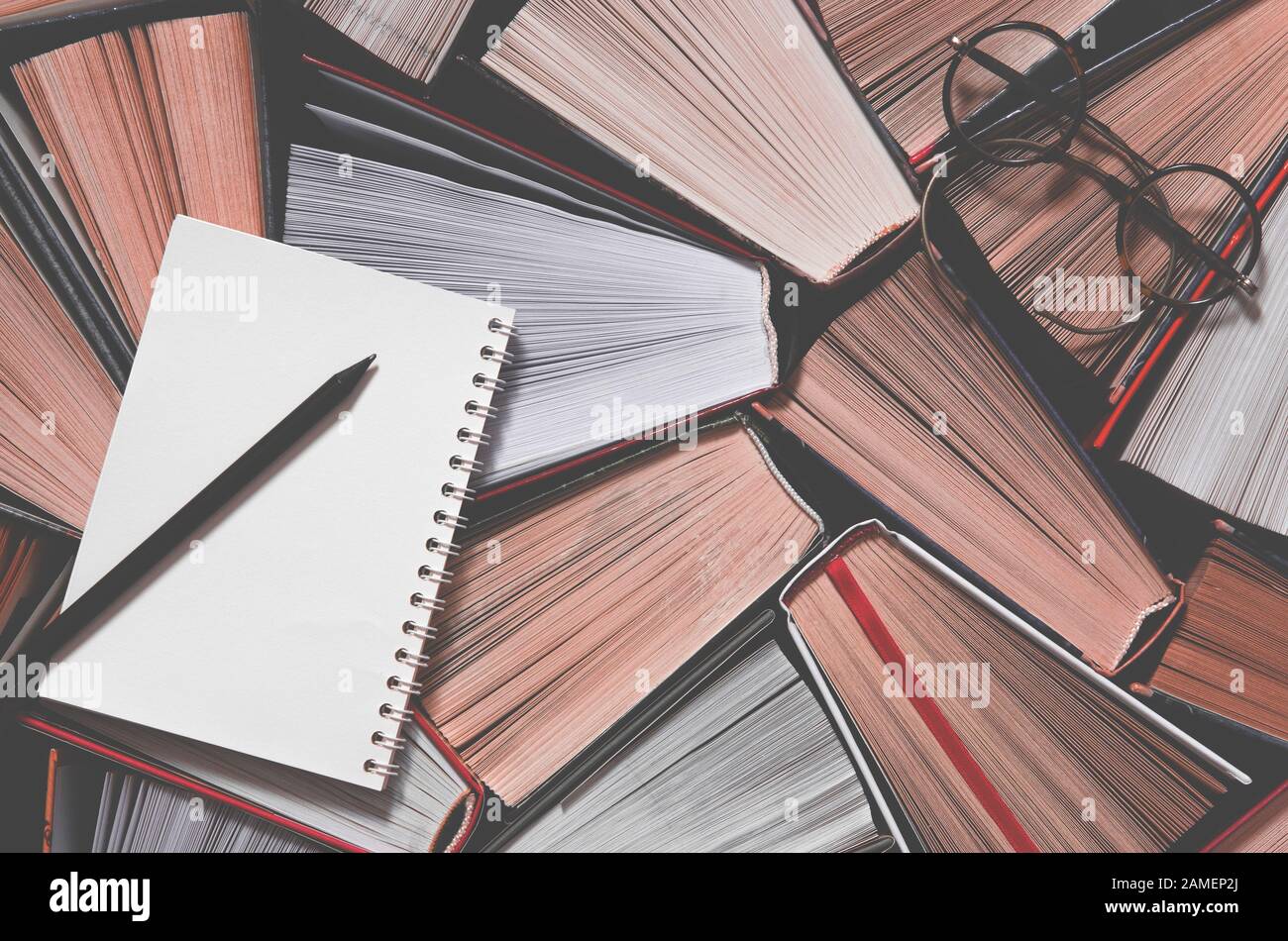 Library. Old open books stand on a bookshelf ready to read. Close-up ...