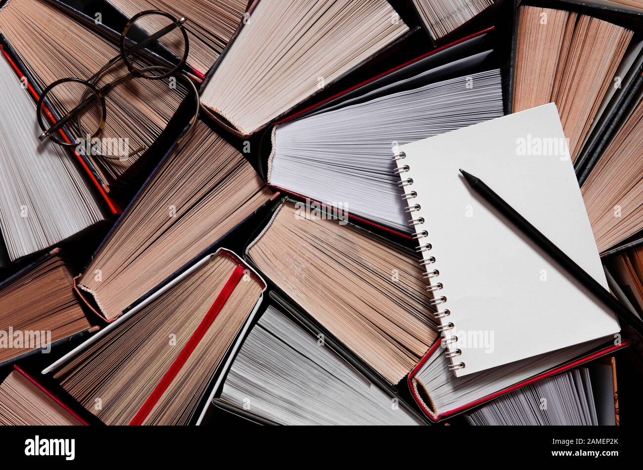 Library. Old open books stand on a bookshelf ready to read. Close-up ...
