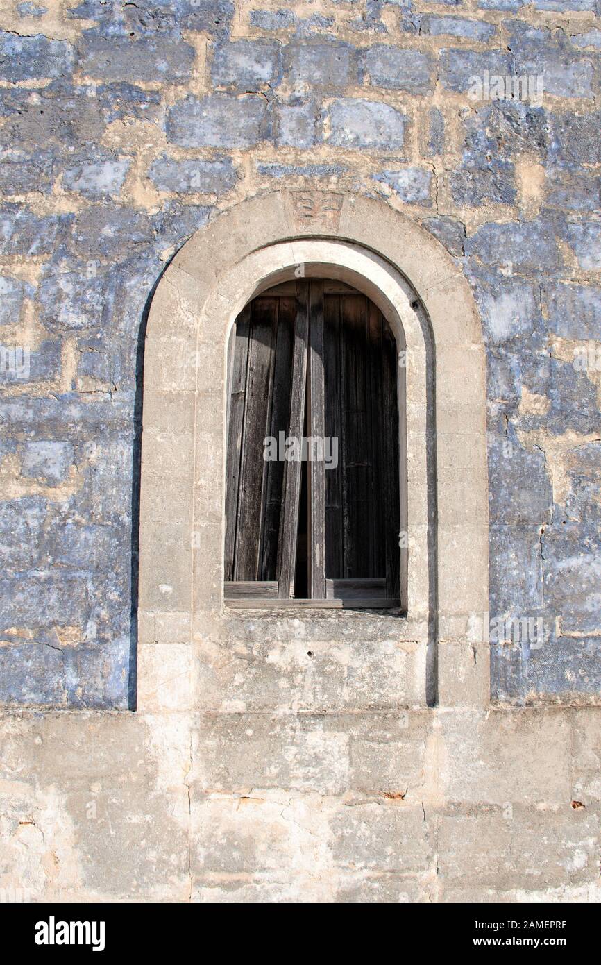 Ancient stone window of an old stone house in a countryside village in ...