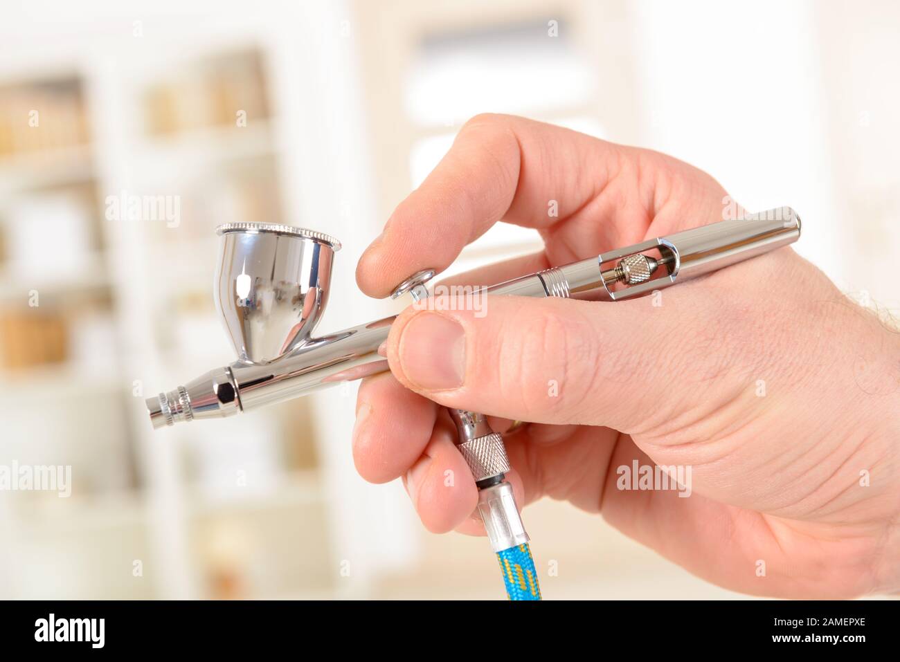 Professional airbrush in artist hand Stock Photo - Alamy