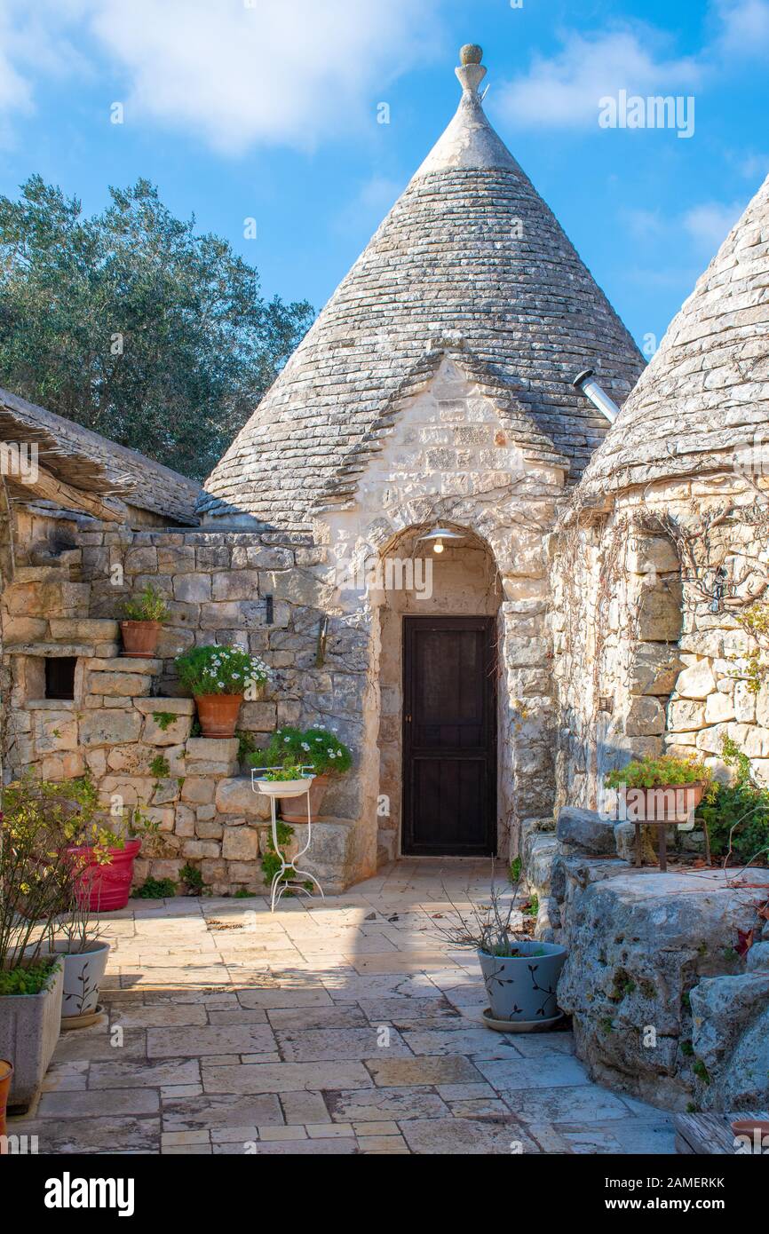 Group of Trulli house with garden, traditional old houses and old stone ...