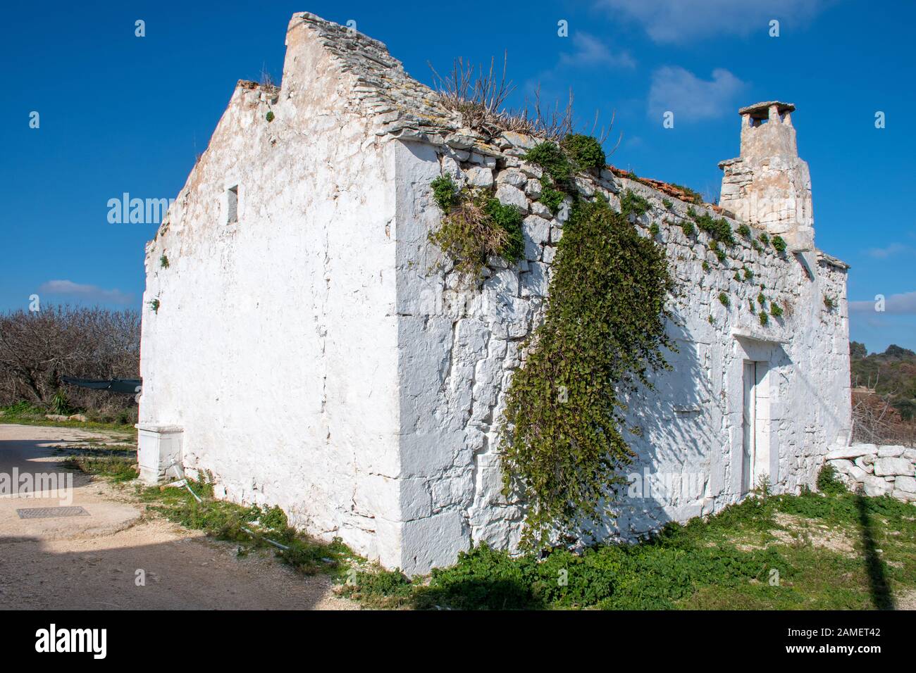 Ancient old white stone house in a countryside village in Puglia, Italy ...