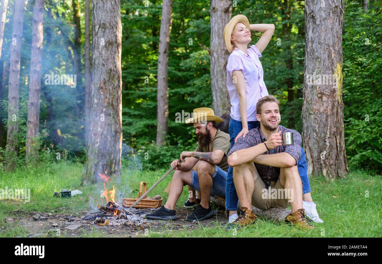 Company friends enjoy relaxing together forest. Company most important ...