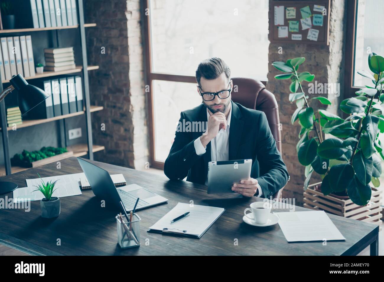 Photo of attentive handsome business chief guy focused reading e-reader ...