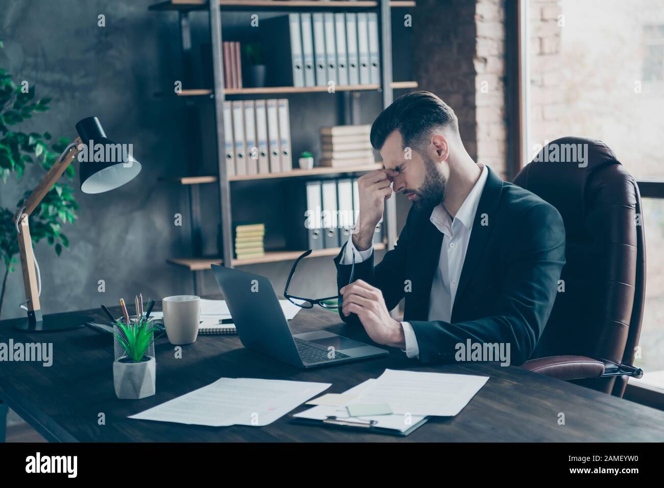 Profile photo of tired depressed business brunet guy taking off ...
