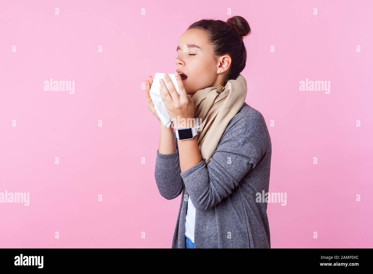Influenza. Portrait of unhealthy brunette teenage girl with bun ...