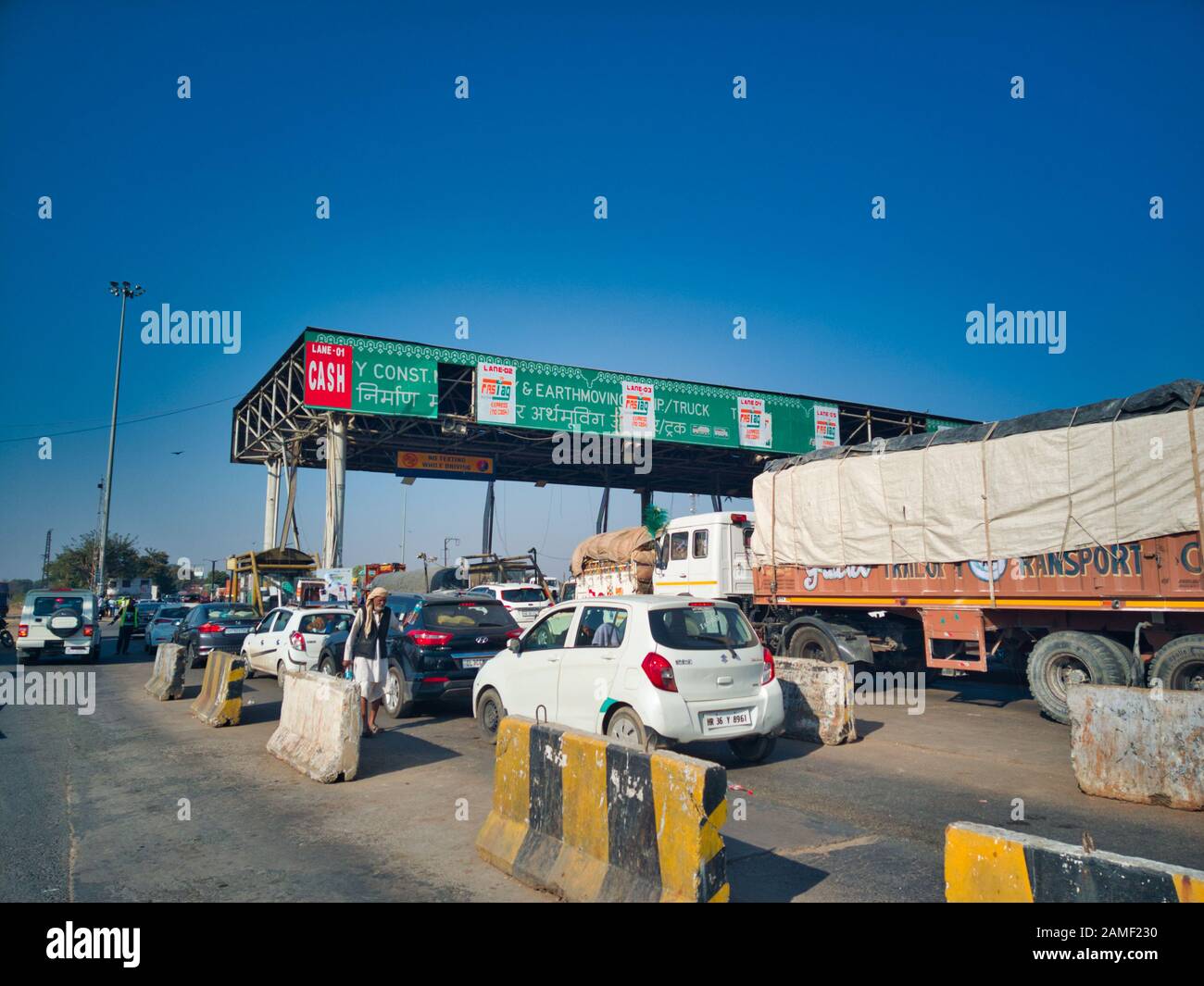 Fastag enabled toll booth plaza and toll gates with traffic lined up in ...