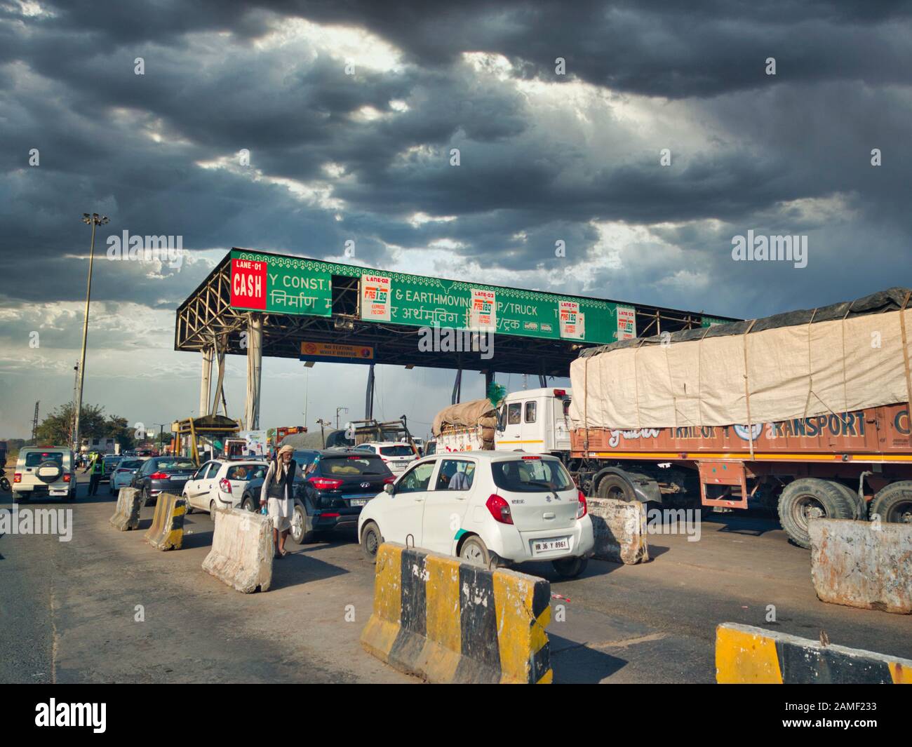 Fastag enabled toll booth plaza and toll gates with traffic lined up in ...