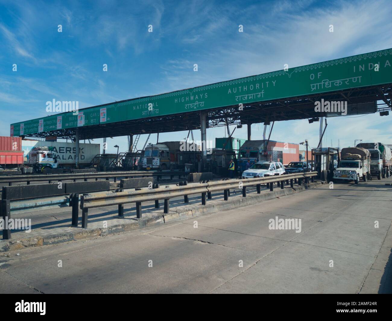 Fastag enabled toll booth plaza and toll gates with traffic lined up in ...