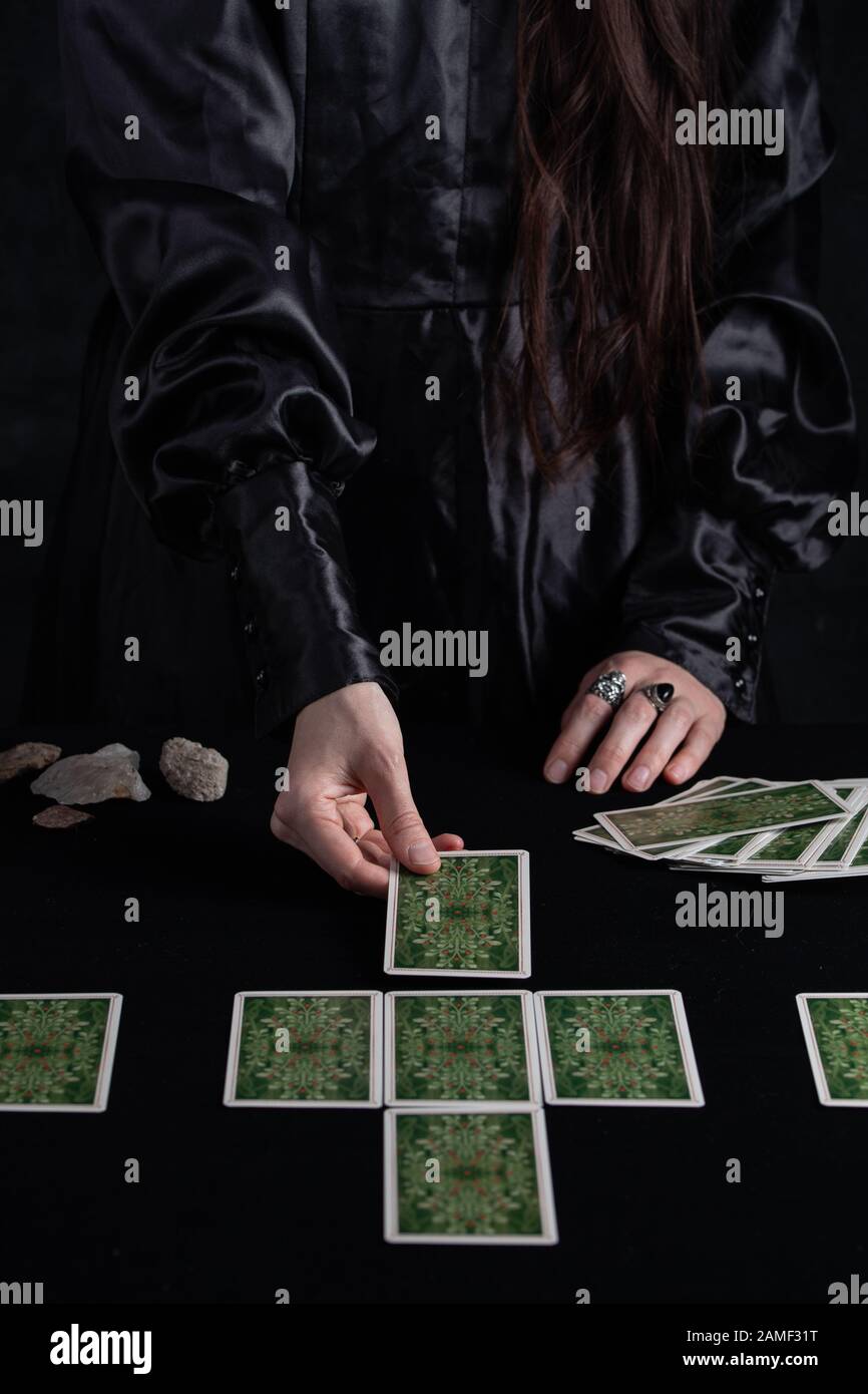 Female tells the future with playing cards. Tarot card concept on the ...