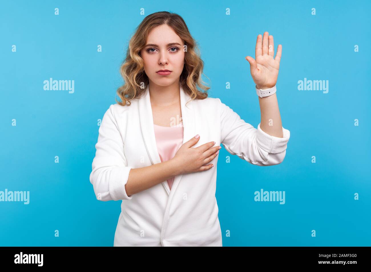 I promise. Portrait of beautiful woman with wavy hair in white jacket ...