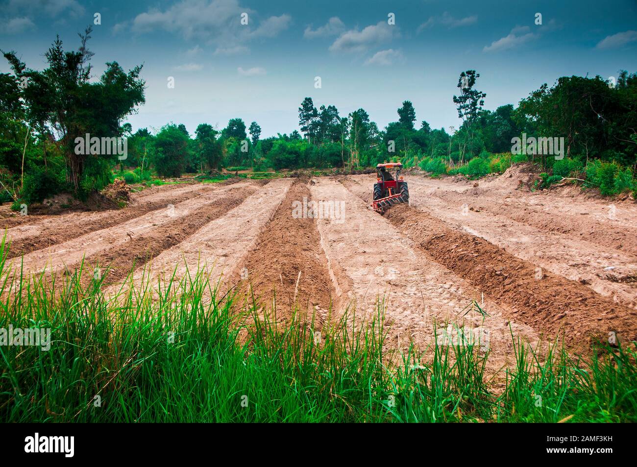 Agricultural tractor plowing fields preparing land for sowing and ...