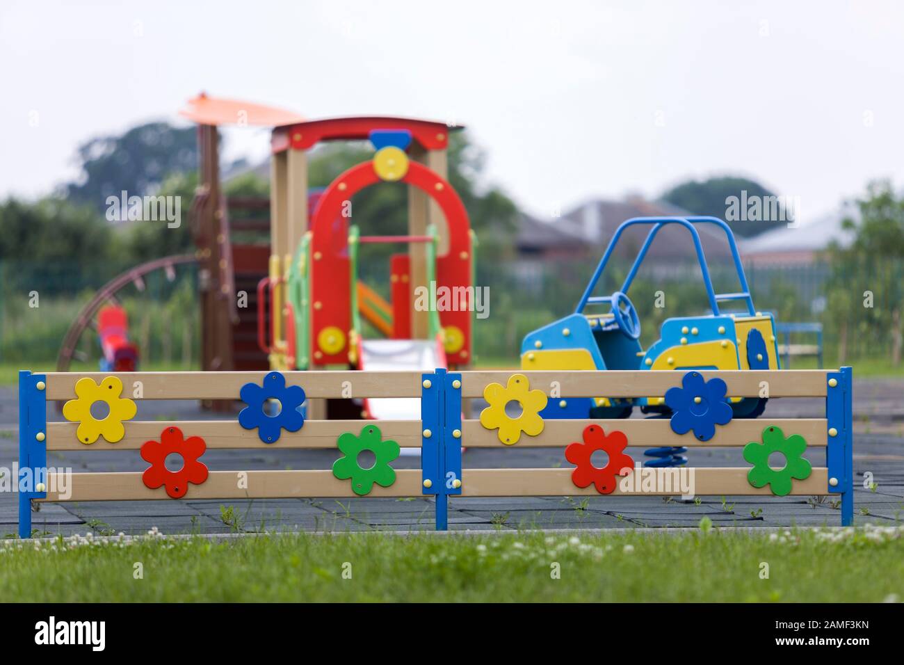 Nursery playground with bright toy car and colorful fence. Children ...