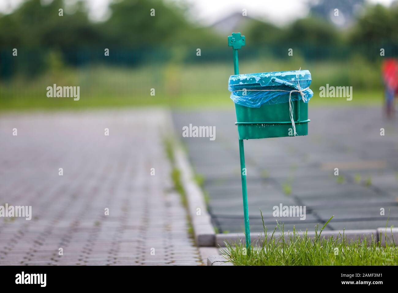 Garbage bin outdoor on blurred sunny background Stock Photo - Alamy