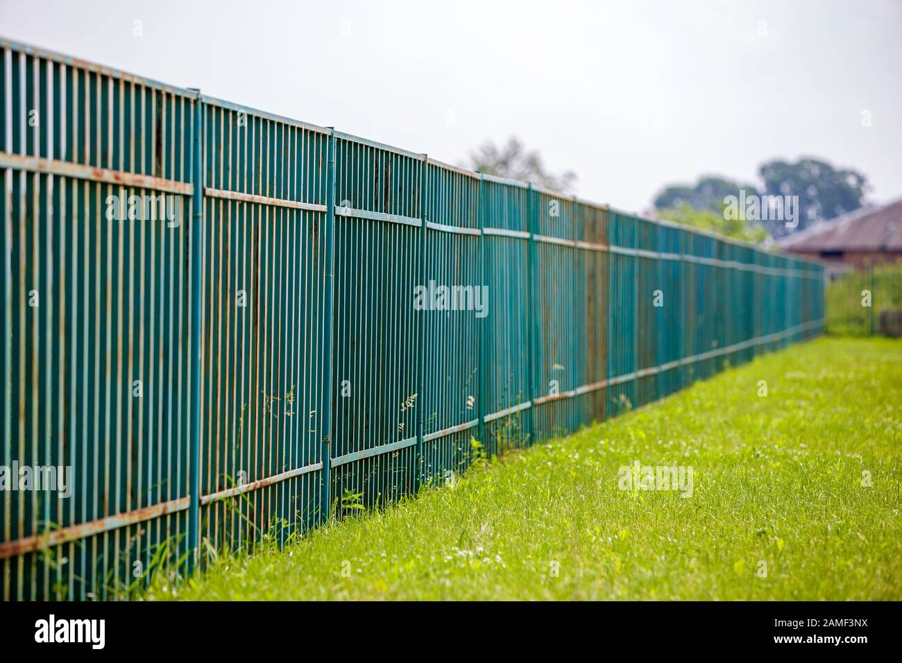 Long rusty old metalic fence Stock Photo - Alamy