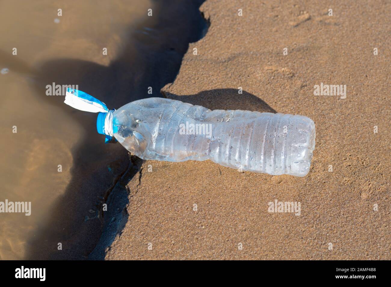 Plastic trashes on the beautiful sandy beach Stock Photo - Alamy
