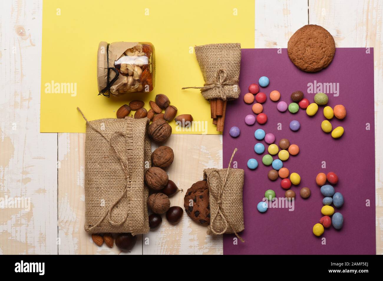 Healthy natural sweets on light wooden texture background. Bag with ...