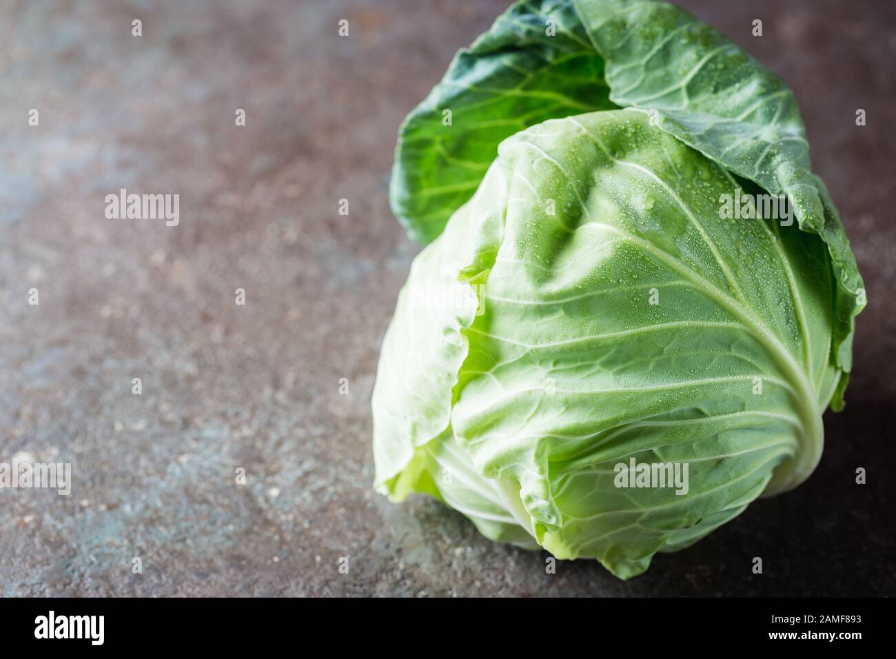 Fresh green garden cabbage on rustic stone background Stock Photo - Alamy