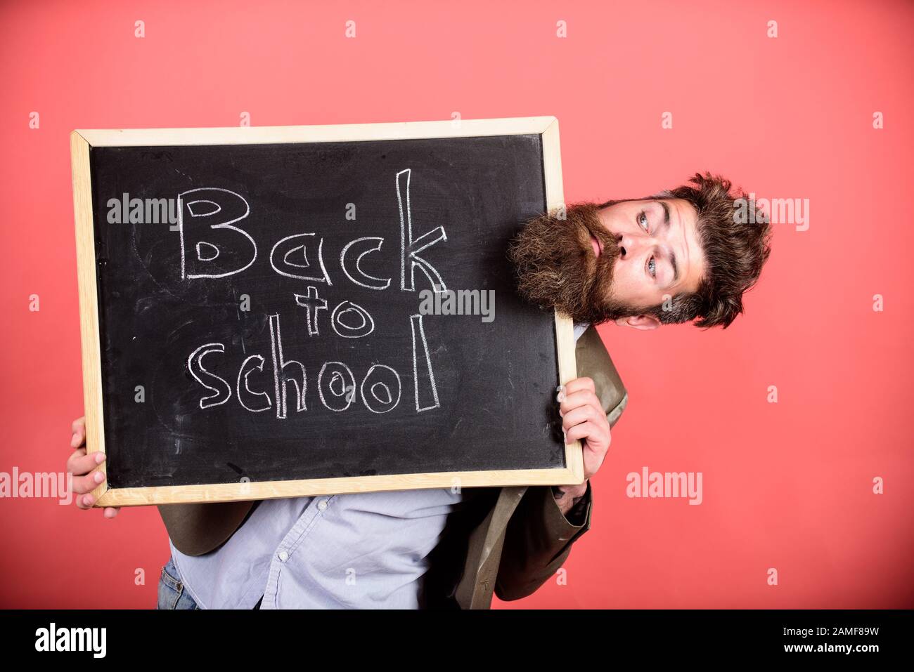 School and teacher wait for you. Teacher or bearded educator stands and ...