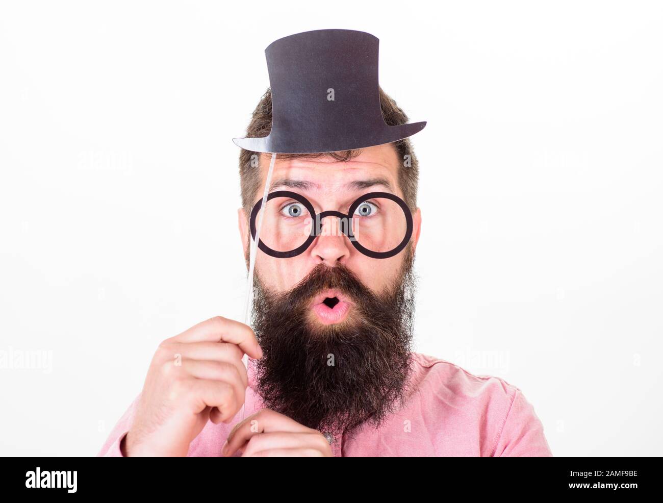 Man bearded hipster hold cardboard top hat and eyeglasses to look ...