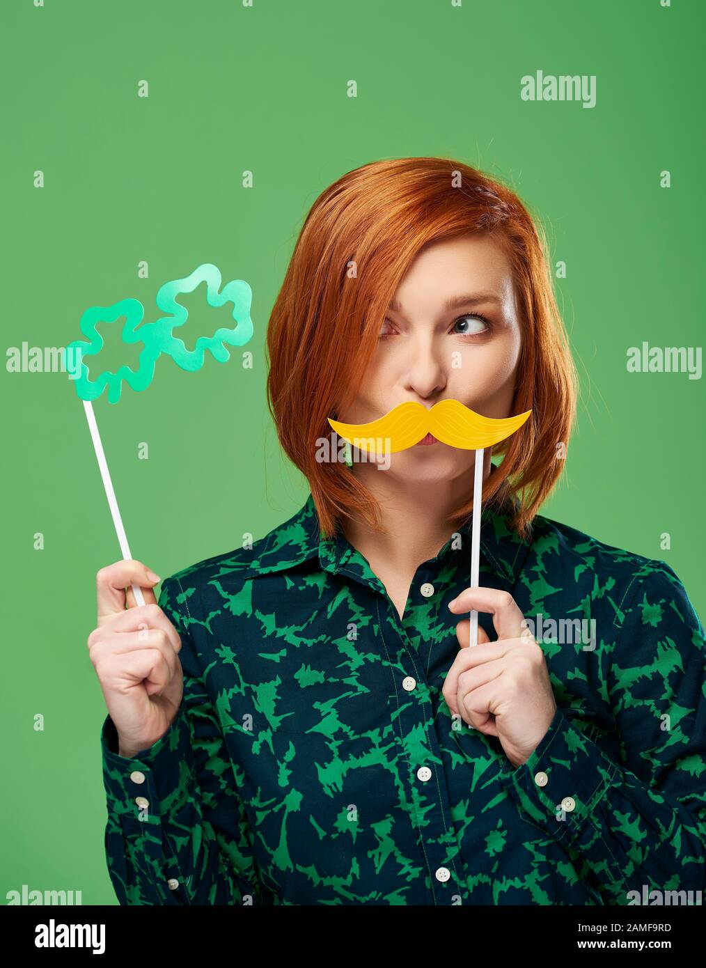 Young woman with playful mask posing in studio shot Stock Photo - Alamy