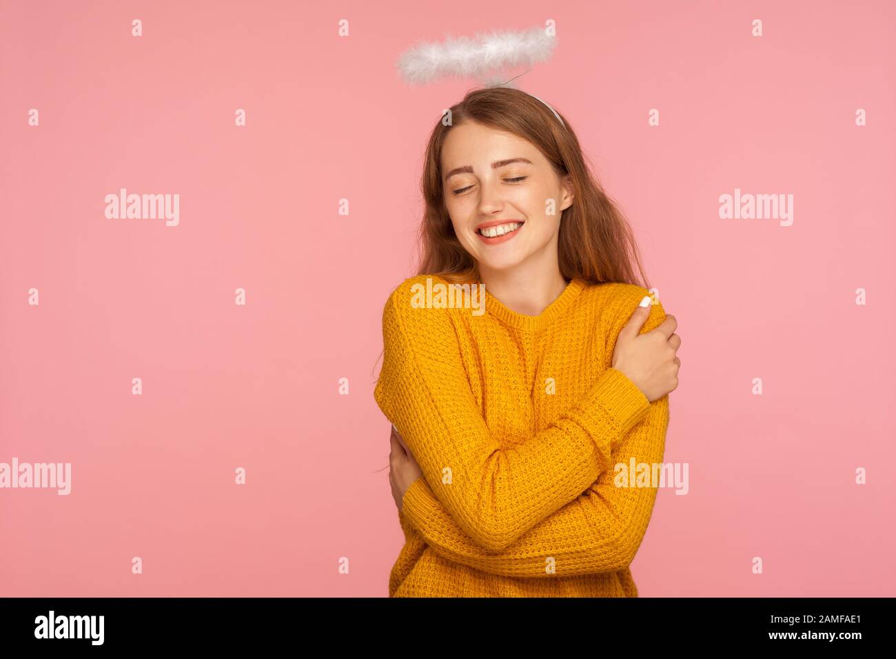 I love myself. Portrait of gorgeous angelic ginger girl with halo over ...